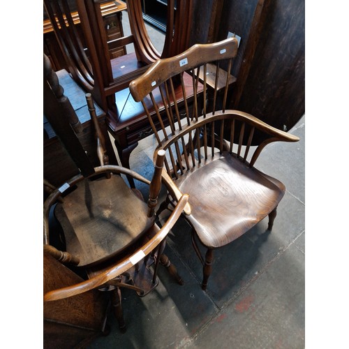 A 19th century comb back elm Windsor chair, together with two similar ...
