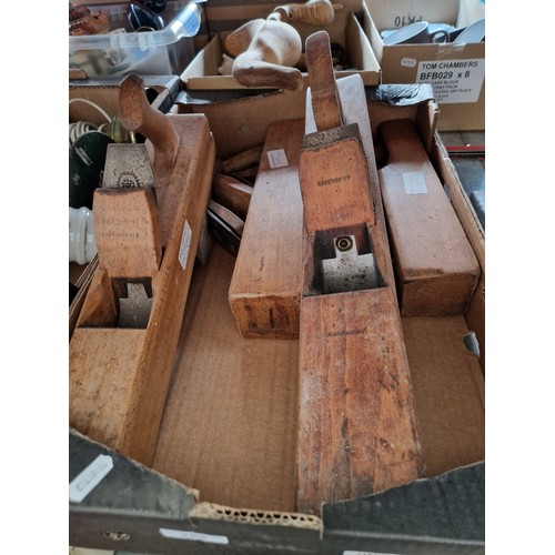 A box containing five vintage wood planes