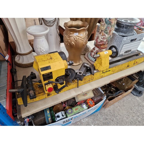 A Perform wood turning lathe.