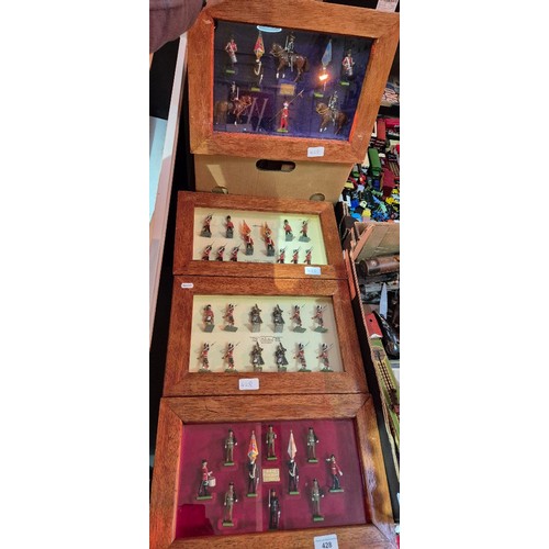 Four display cases of Britains soldiers.