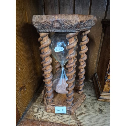 A ships half hour glass timer in carved pitch pine surround with twist ...