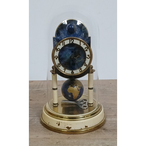 A German 400 day Universe clock by Kaiser with glass dome.
