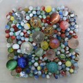 A quantity of mainly glass marbles, various designs.