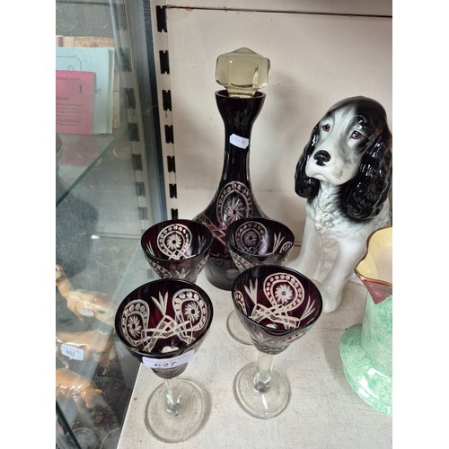 A Bohemian style cut red flash glass decanter and matching glasses.