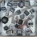 A tray of assorted digital watch parts.