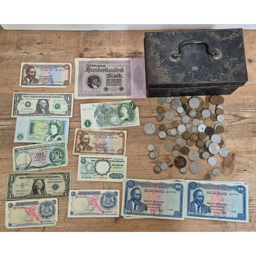 A money tin of assorted coins & banknotes to include some silver coins etc.