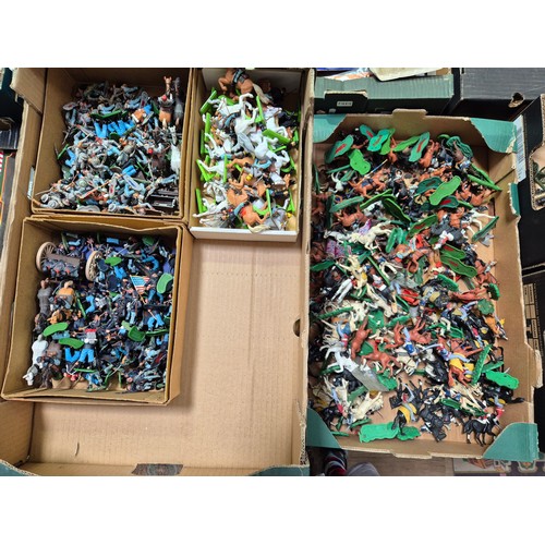 Two boxes of assorted plastic toy soldiers.