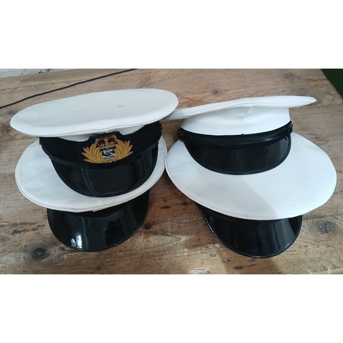 Four Royal Navy officers caps.