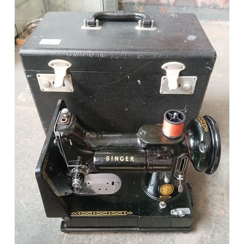 A Singer 222K featherweight sewing machine.