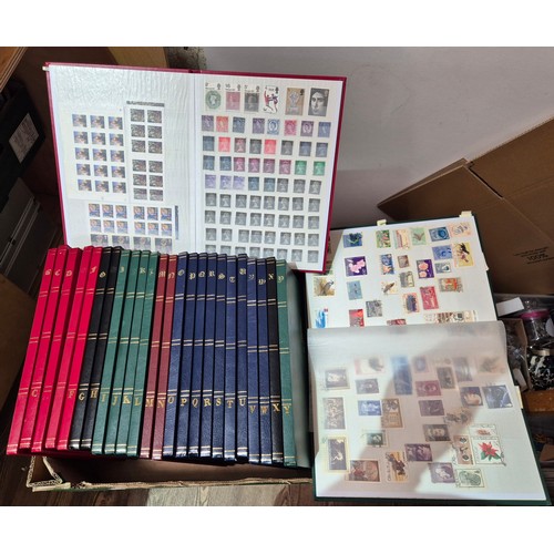 Twenty six assorted stamp albums containing various world stamps.