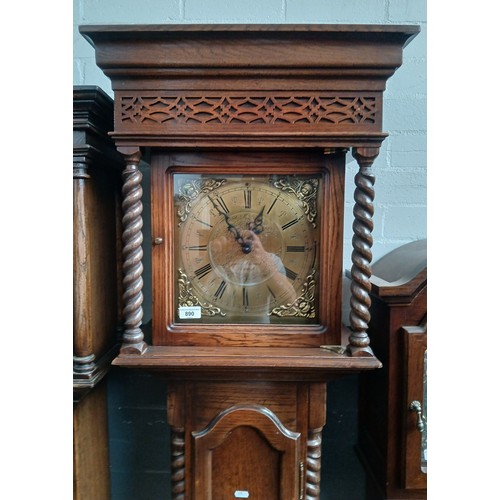A reproduction triple weight driven oak long case clock, the dial ...