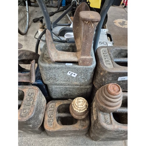 Four 56 lb weights, a shoe last & a set of graduated scale weights.