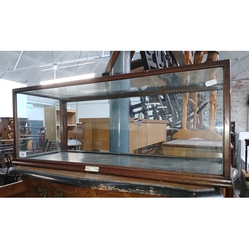 A vintage table top glass display cabinet.