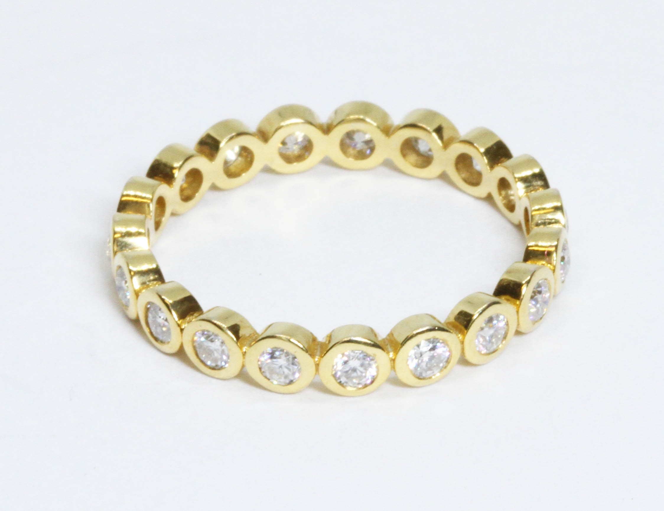 A colourless stone eternity band, unmarked, gross weight 2.2g, size Q.