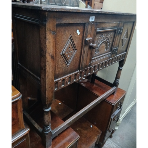 A Priory style oak cabinet.