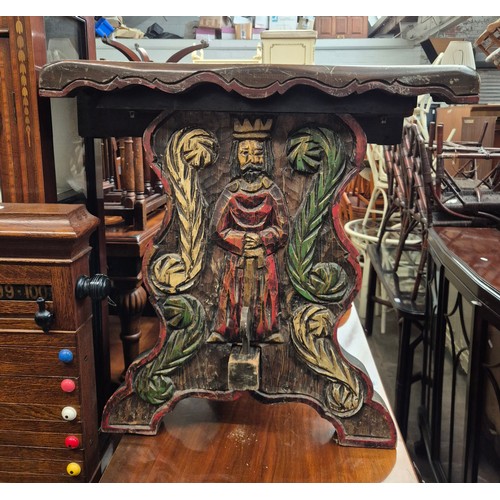 A carved chess table with pieces.