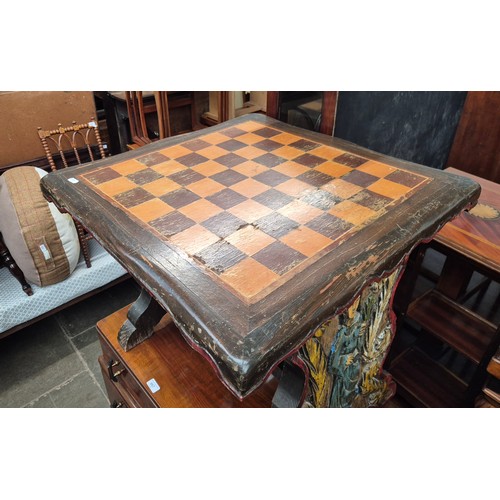 A carved chess table with pieces.