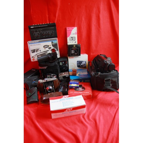 A box containing an assortment of film-, digital- and video-cameras ...