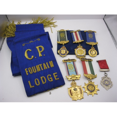 A Masonic sash and a selection of Masonic and RAOB jewels, some silver