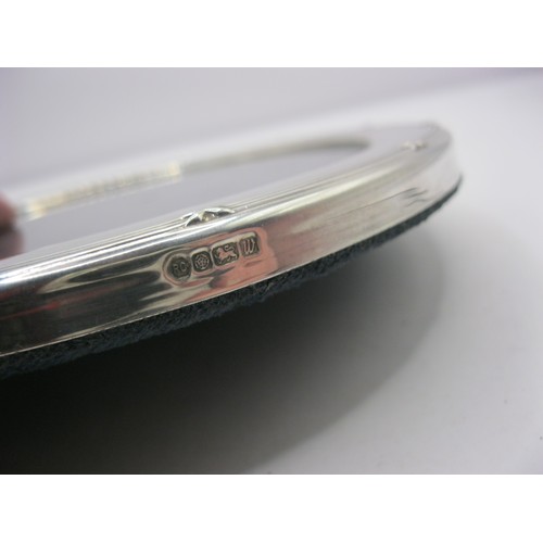 A circular sterling silver photograph frame of some weight, in ...