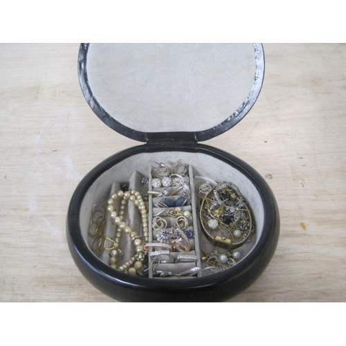 A vintage circular jewellery box containing mainly costume earrings ...