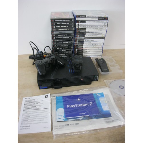 A Playstation 2 gaming console with accessories including camera and ...