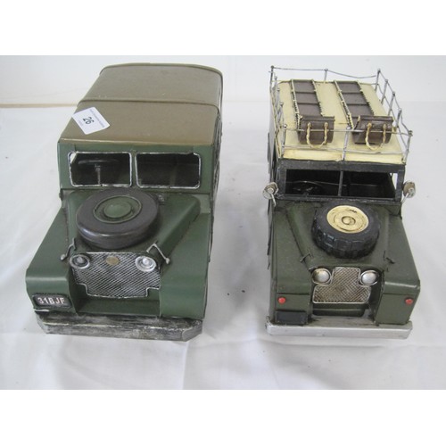 A pair of relatively modern tin-plate models of Land Rovers, believed ...