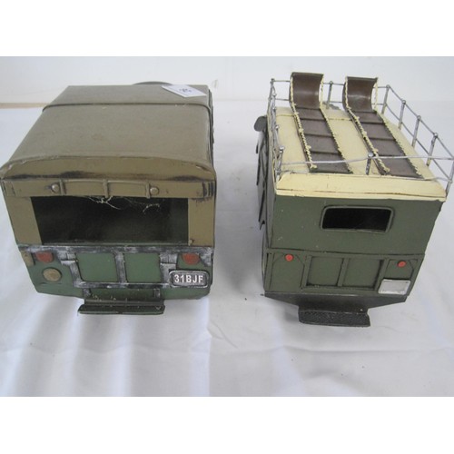 A pair of relatively modern tin-plate models of Land Rovers, believed ...