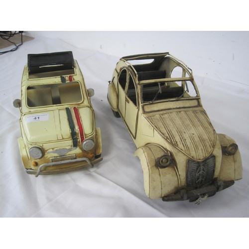 A pair of tin plate cars, one a Fiat 500, the other a Citroen 2CV