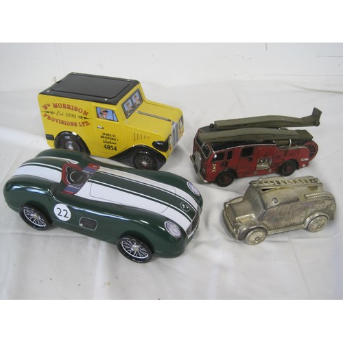 A pair of money boxes in the form of fire engines, one in white metal ...