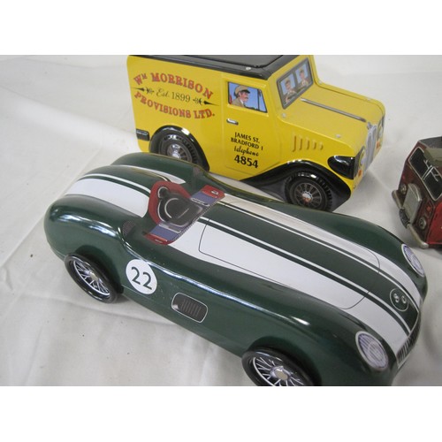 A pair of money boxes in the form of fire engines, one in white metal ...