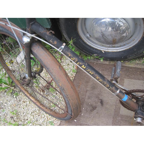 A pair of vintage push bikes - one a Triumph, the other a BSA