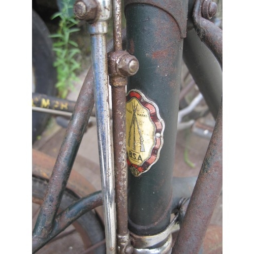 A pair of vintage push bikes - one a Triumph, the other a BSA