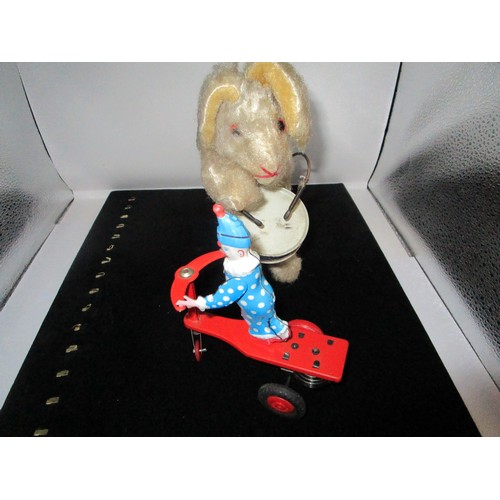 Two clockwork/wind up toys, Drumming Rabbit and Clown on Trike