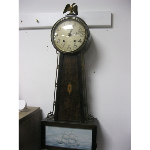 A Gilbert early 20th century 8 day banjo wall clock with eagle pediment ...