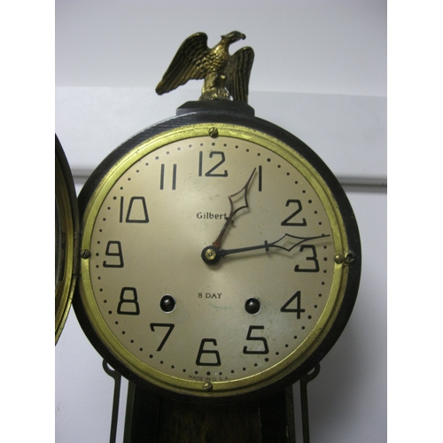 A Gilbert early 20th century 8 day banjo wall clock with eagle pediment ...