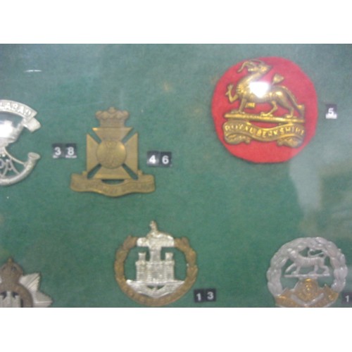A framed and glazed collection of WW1 military cap badges, in good ...