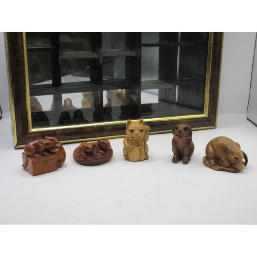 Five netsuke and okimono, with a glazed display case for small objects ...