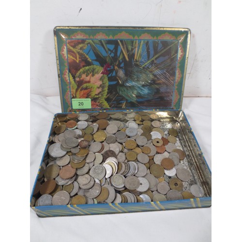 A vintage biscuit tin of mixed world coins includes some silver