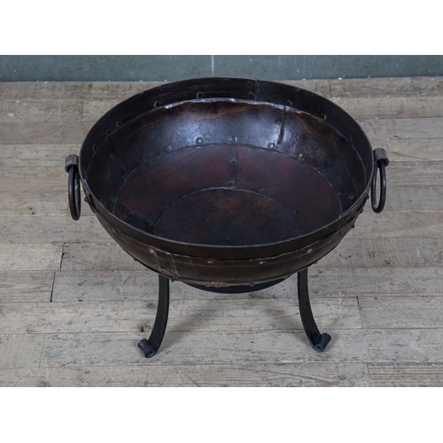 Metal 'Kadai' fire pit of riveted construction on iron stand ...