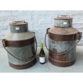 Two large and heavy milk churns. Constructed of galvanised steel with ...