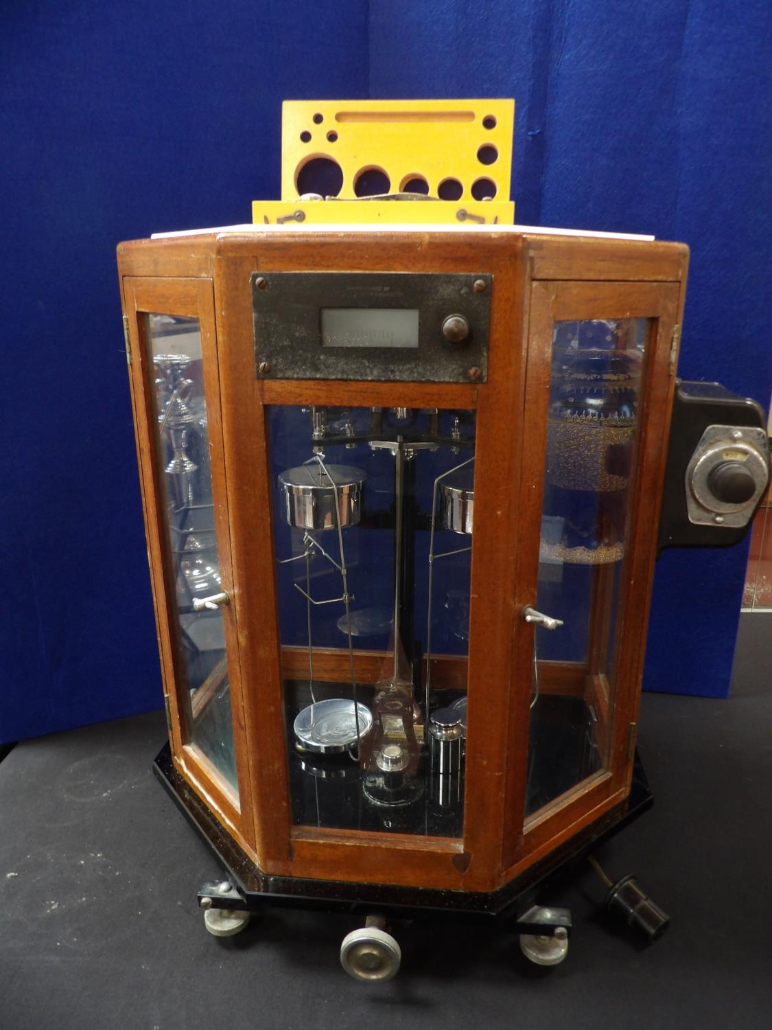 A set of vintage laboratory balance scales contained within a bespoke ...