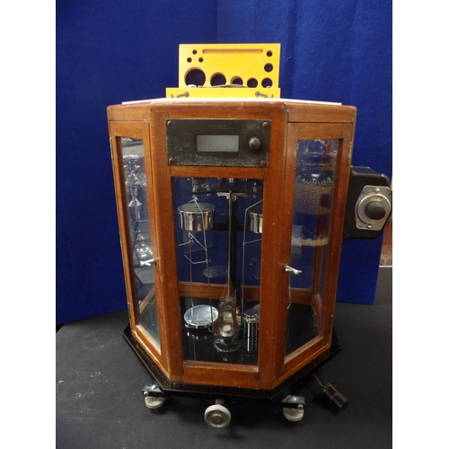 A set of vintage laboratory balance scales contained within a bespoke ...