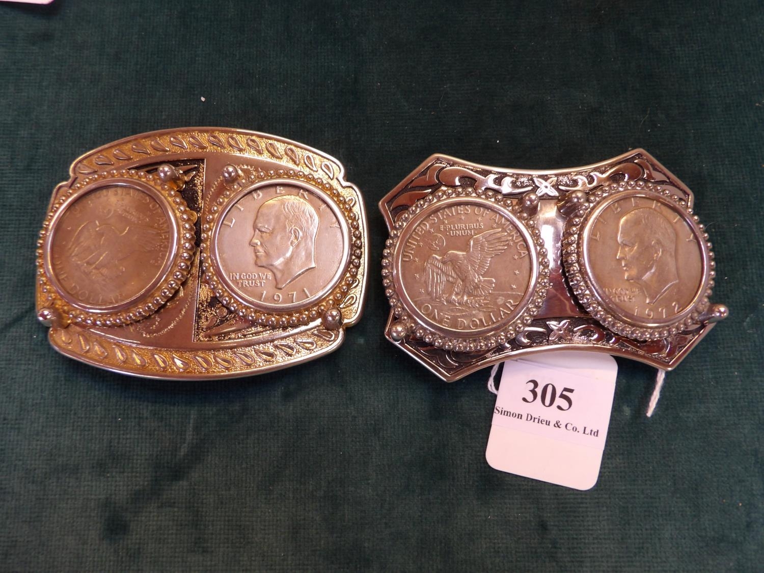 Two American belt buckles each with two inset one dollar coins