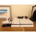 A Sony Playstation 4 games console together with two controllers