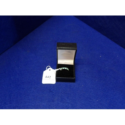 A gold ring set with diagonally set diamonds and emeralds (size O)