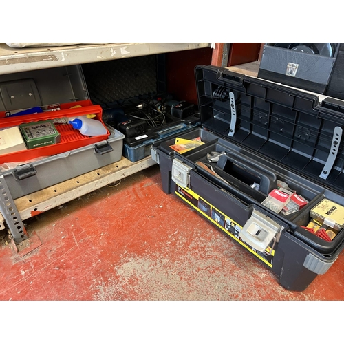 A Bosch cordless drill and work light set together with two tool boxes containing assorted tools