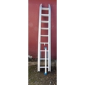 A MacAllister aluminium nine tread triple extension ladder