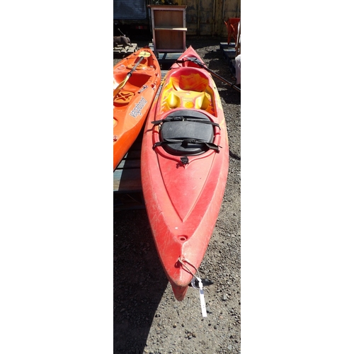 An Ocean Kayak Scupper Pro kayak and paddle
