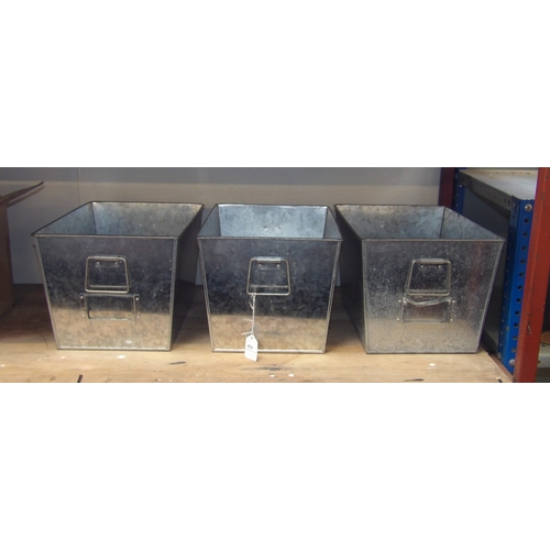 A set of three large galvanised storage boxes